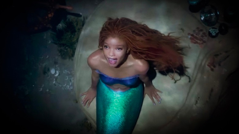 Halle Bailey looks up where they walk in the poster for The Little Mermaid